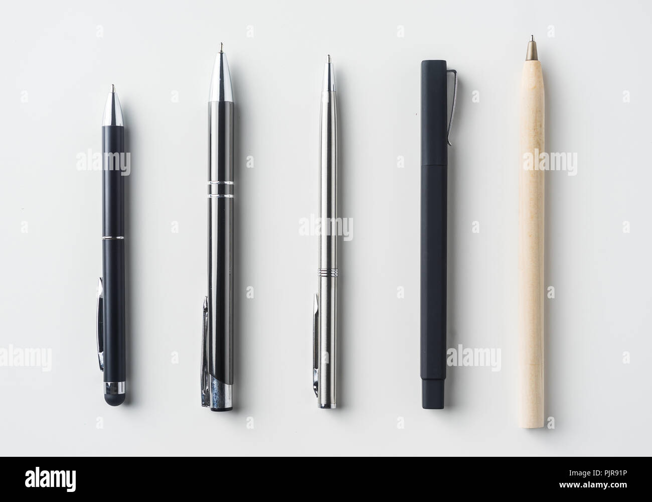Top view of collection of pens on white background desk for mockup ...