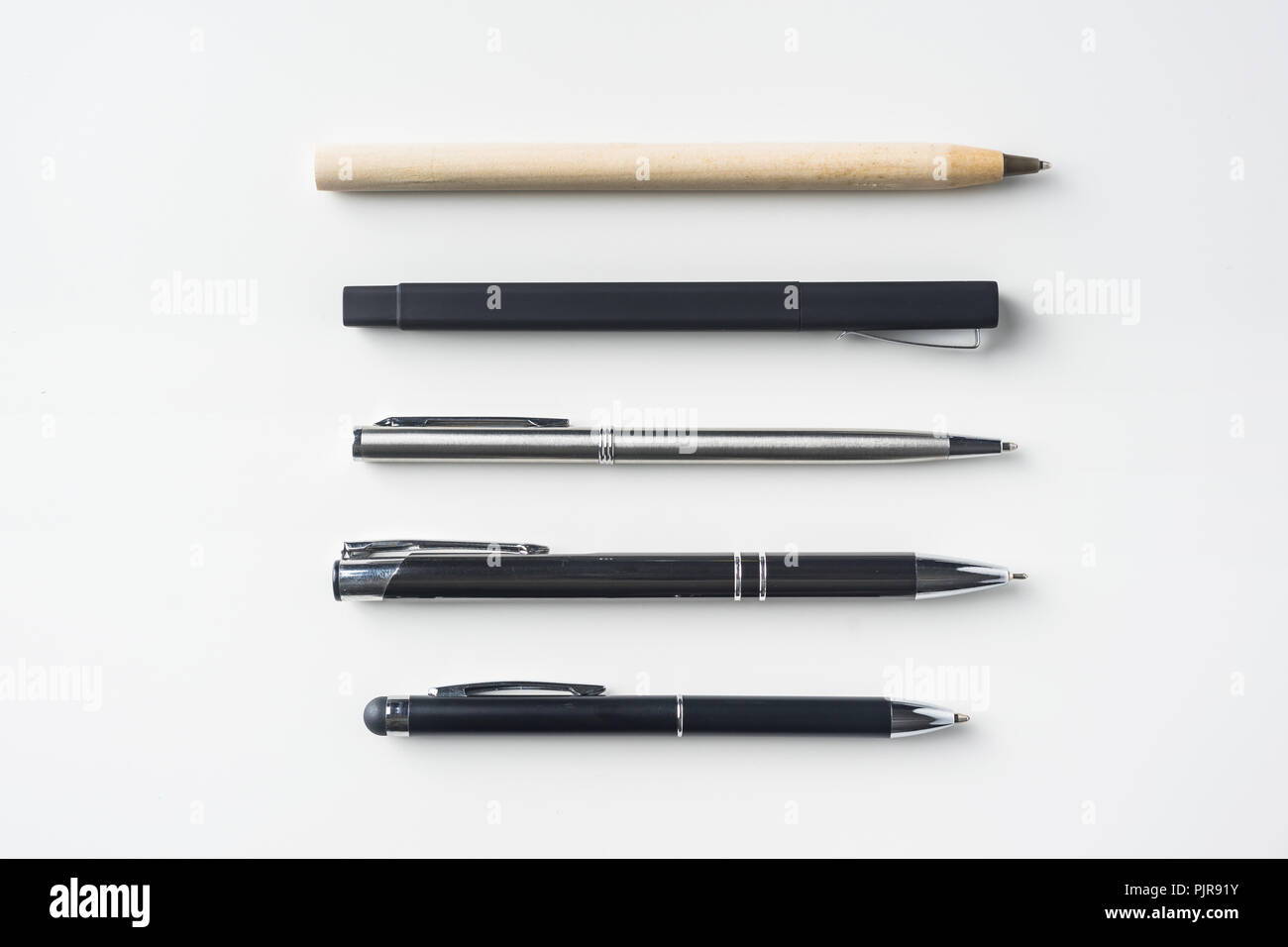 Top view of collection of pens on white background desk for mockup ...