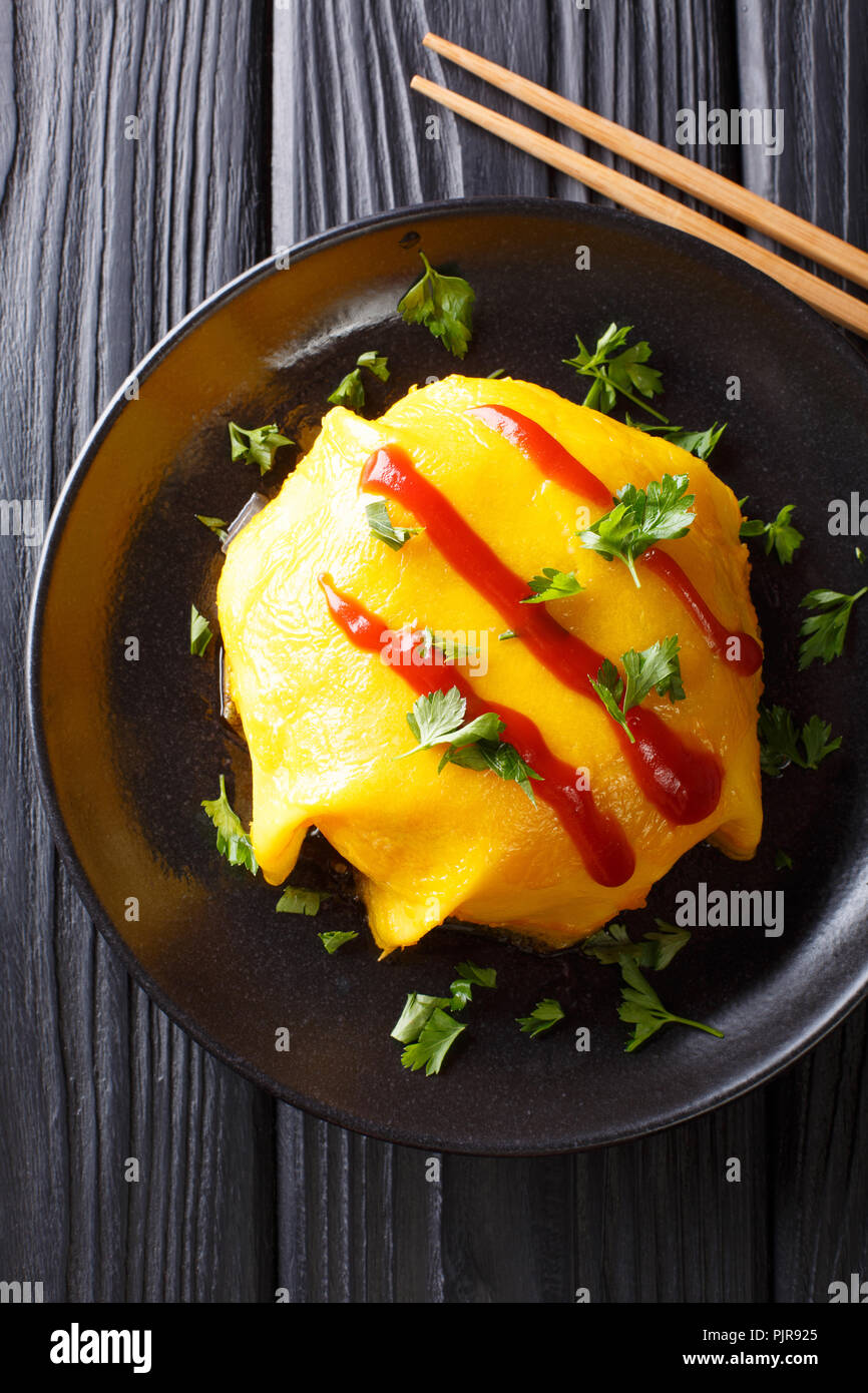 Japanese cuisine: omurice with rice, chicken and vegetables close-up on ...