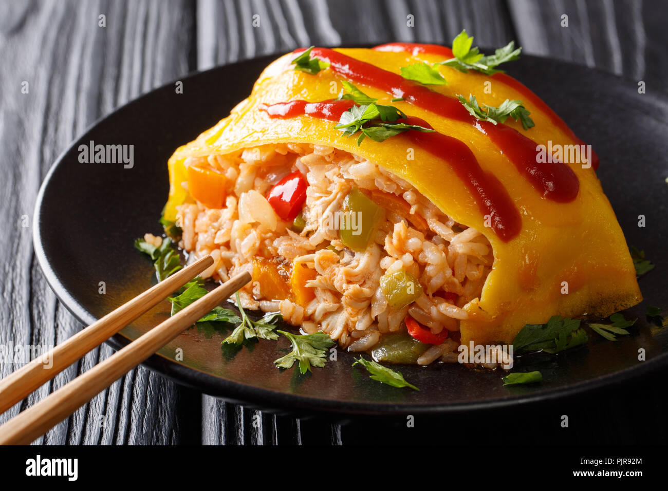 Japanese cuisine: omurice with rice, chicken and vegetables close-up on ...