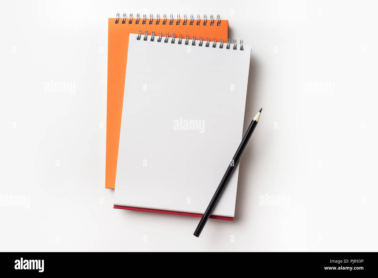 Design concept - Top view of orange and red spiral notebook and color ...