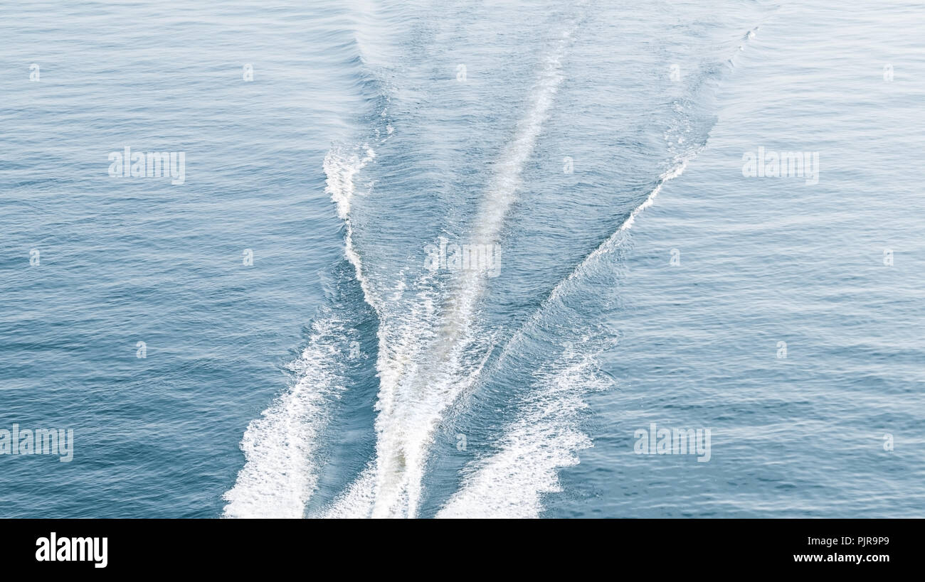 Beautiful waves of a trail on the water surface in the sea after a ...
