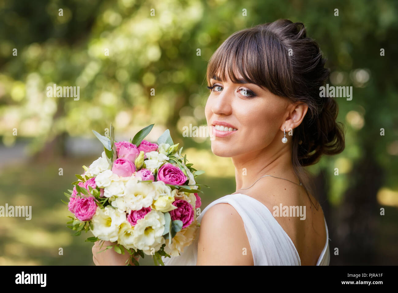 closeup portrait of beautiful smiling bride in wedding white dress with ...