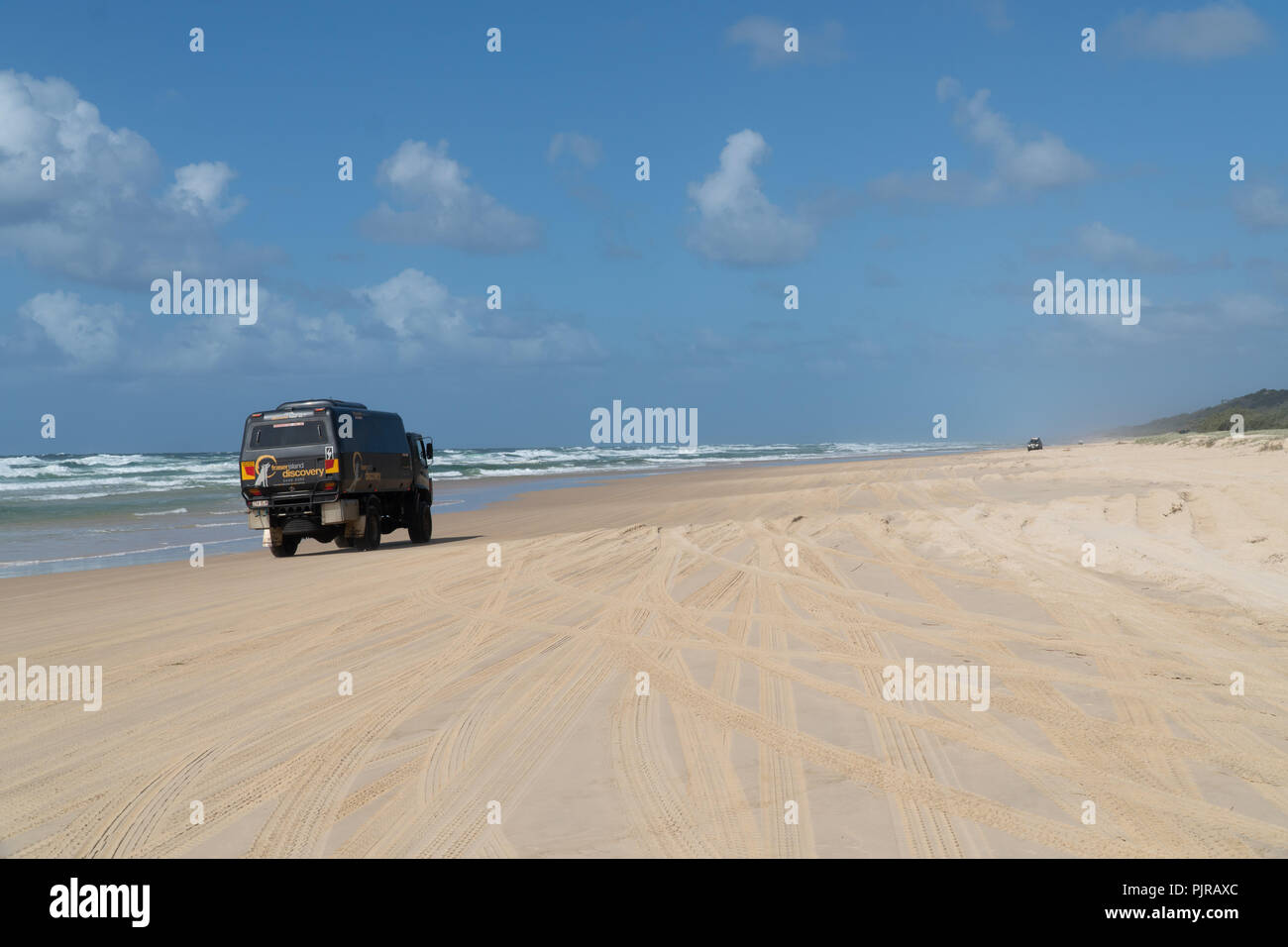 Tourist 4 wheel bus departs from the beach of Fraser Island, Australia ...