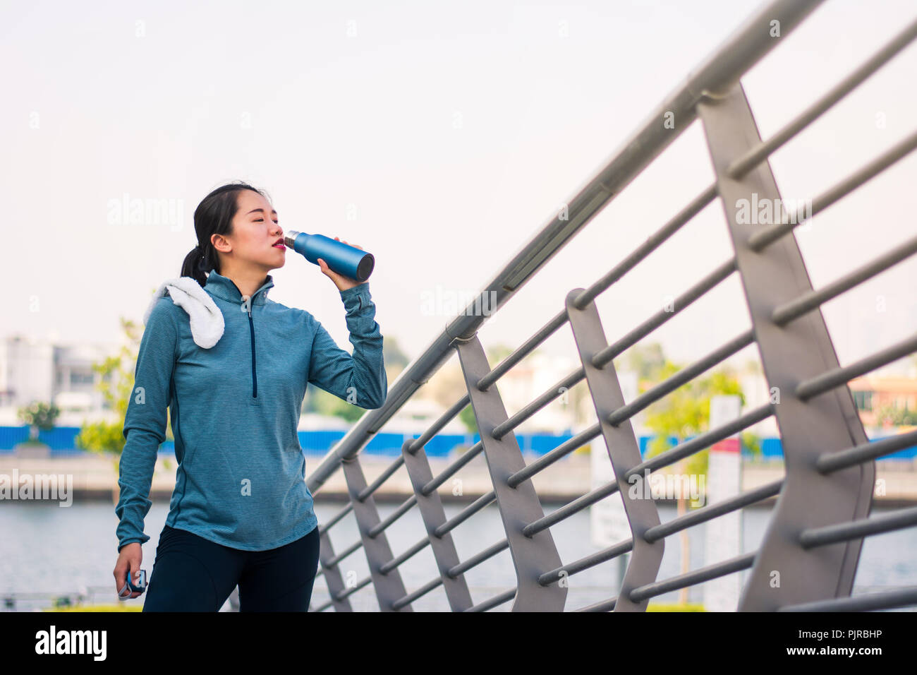 Female runner hydrating after a workout outdoors Stock Photo - Alamy