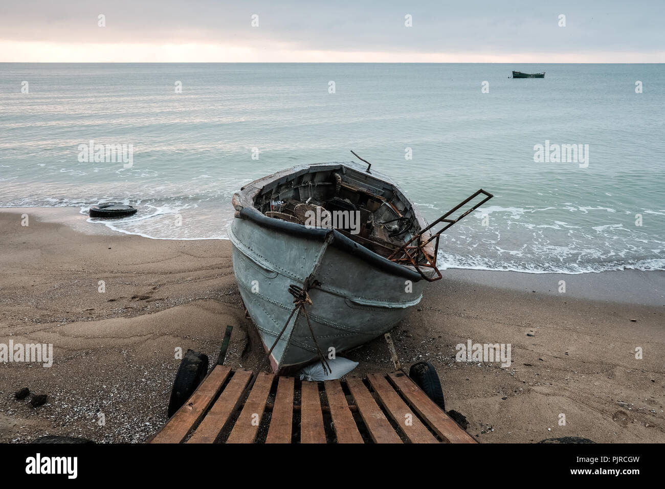 Old boat on the beach near the sea Stock Photo - Alamy