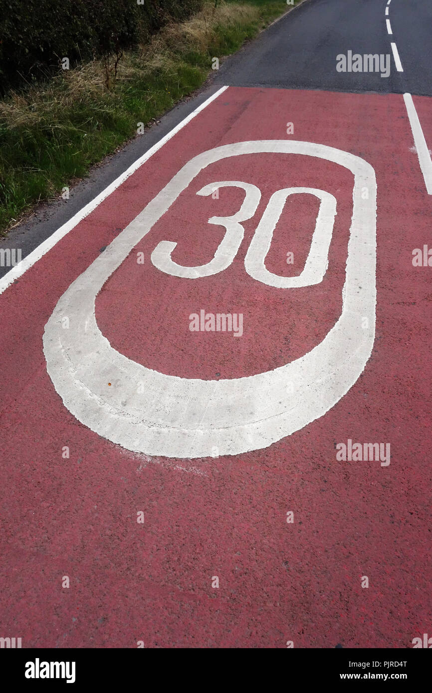 massive 30 symbol on a red covered road in 30 miles an hour speed limit ...