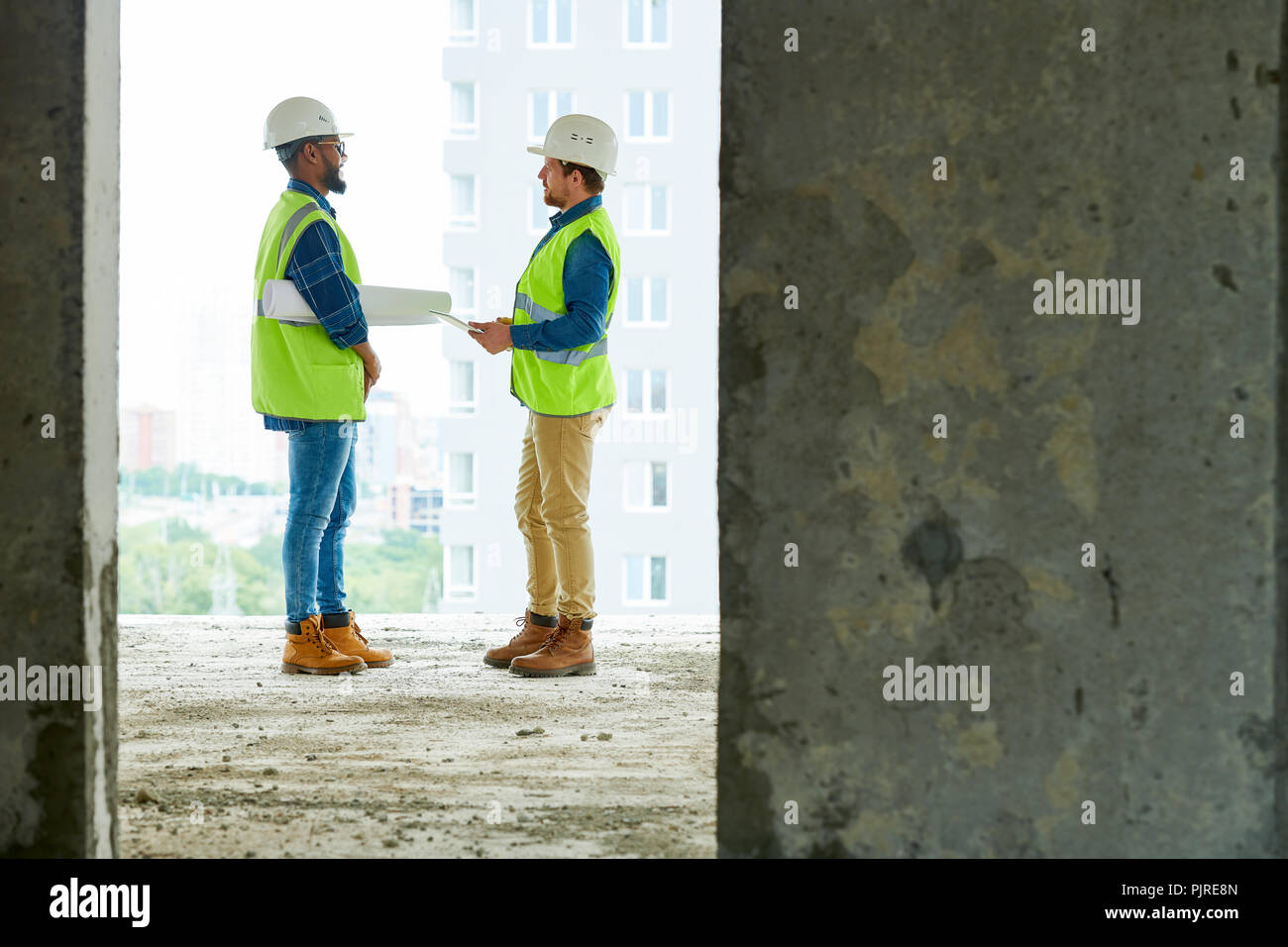 Construction engineers working on apartment building Stock Photo - Alamy