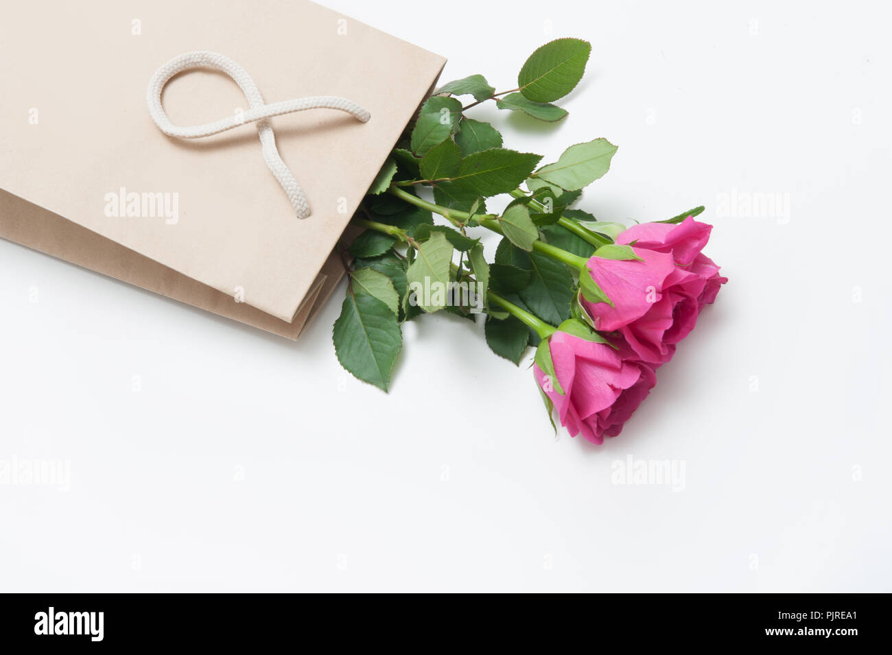 Background with pink roses and greeting card Stock Photo - Alamy