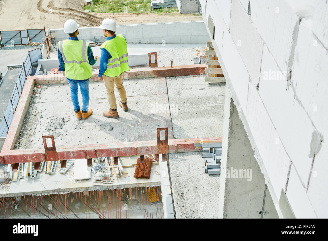 Modern constructors working on new house Stock Photo - Alamy