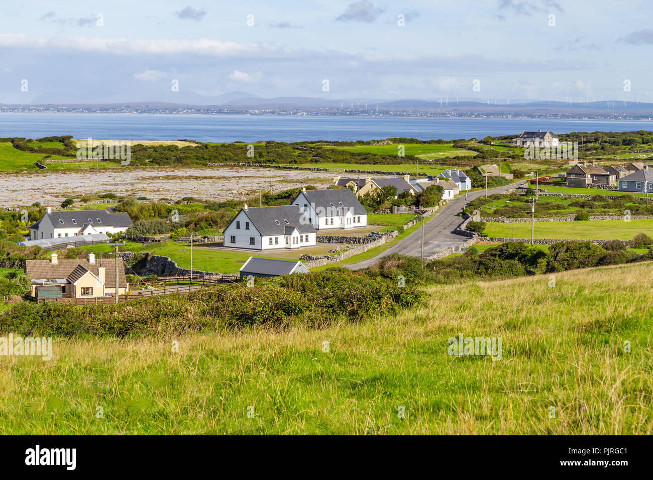 Farms and houses in the Fanore village with Galway bay in background ...