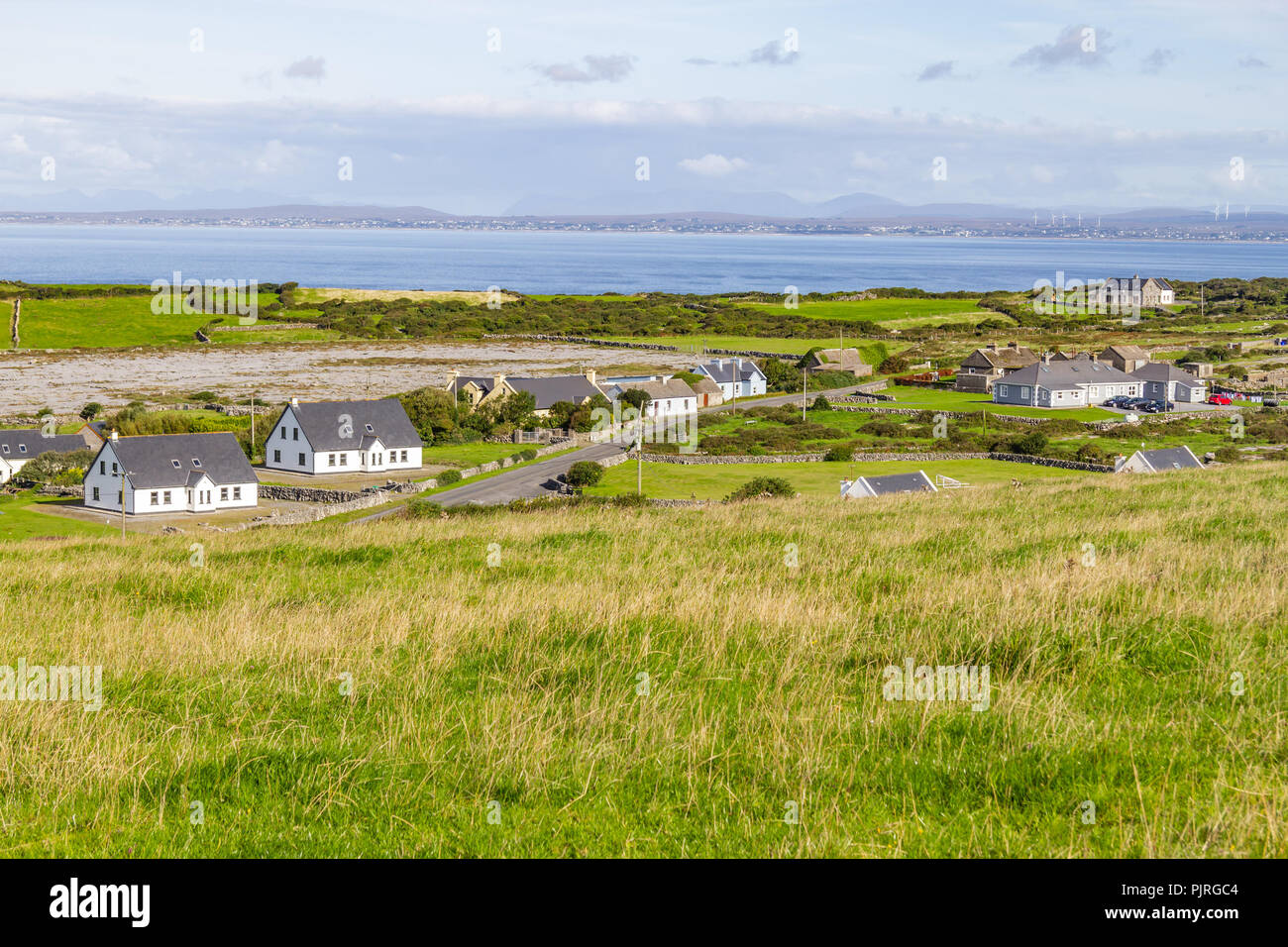 Farms and houses in the Fanore village with Galway bay in background ...