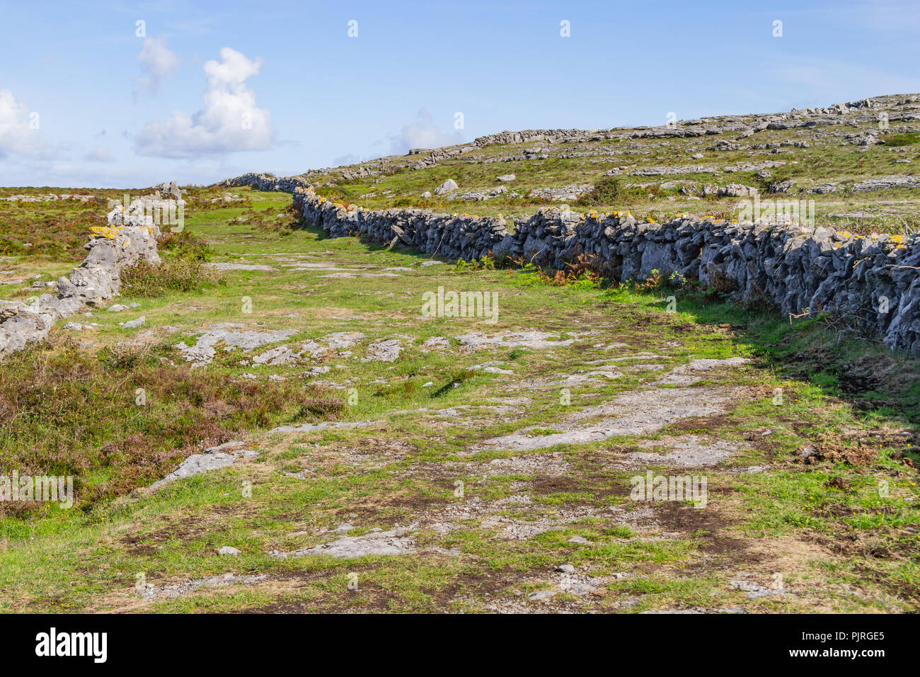 Hiking trail with stone walls in Burren mountains, Fanore, Clare ...
