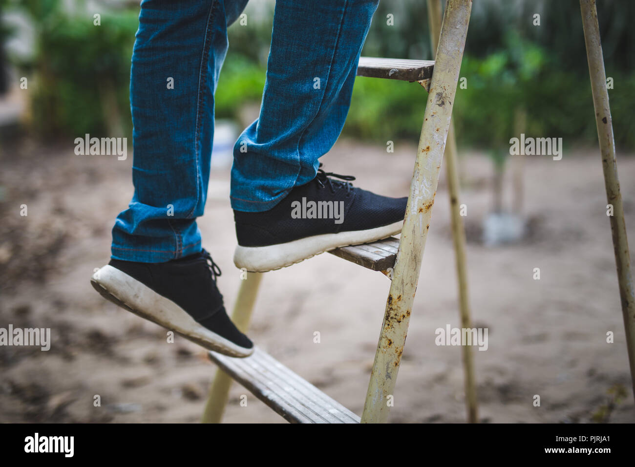 Man climbing a ladder hi-res stock photography and images - Alamy