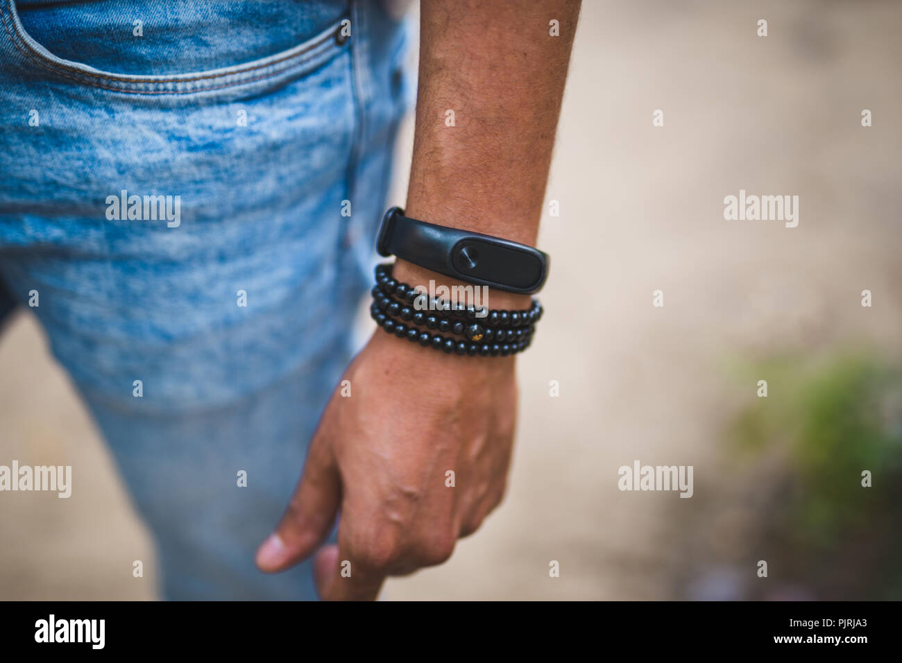 close up of a man's arm wearing a smart band and a bracelet Stock Photo ...