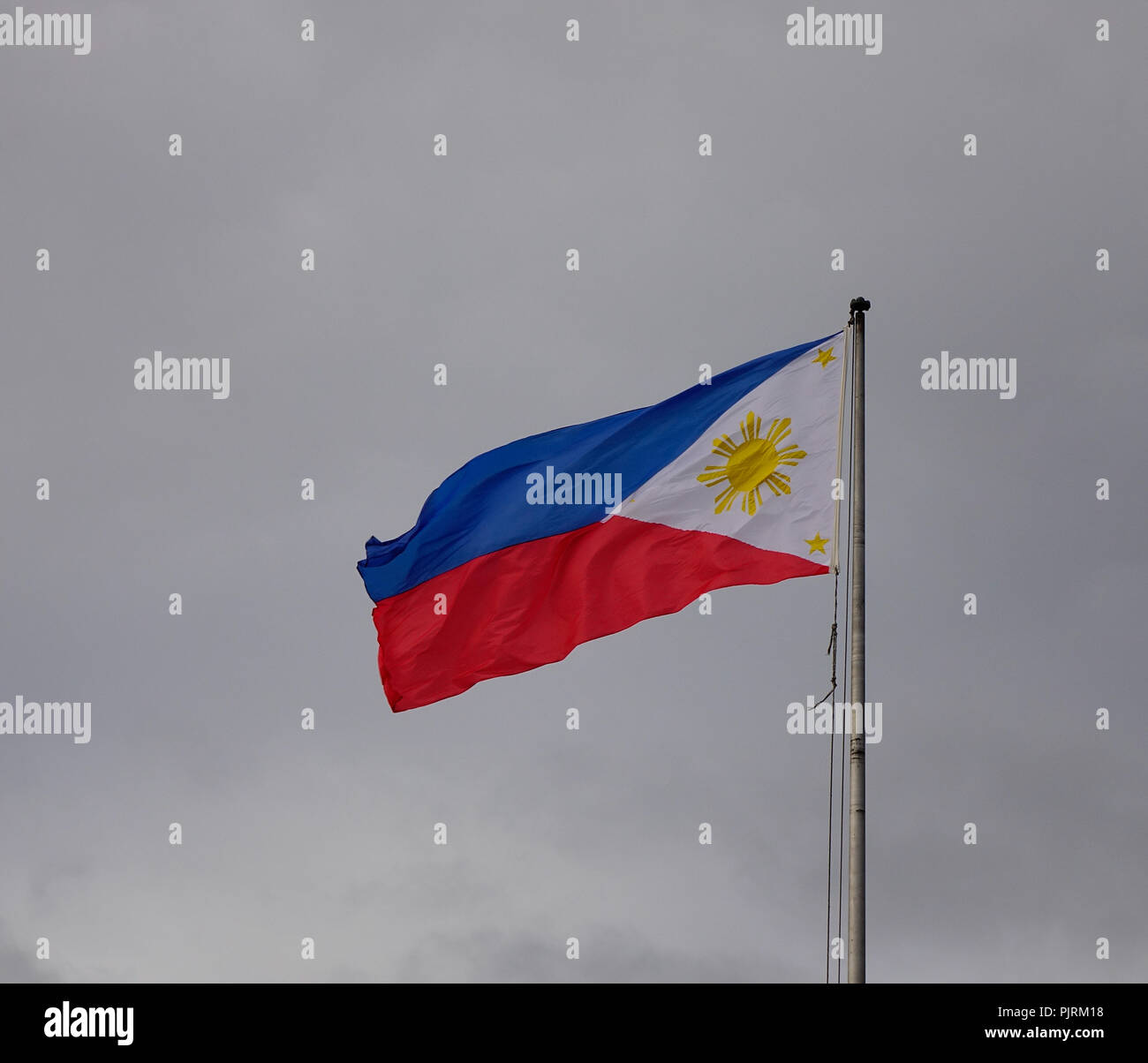 National flag waving in the sky at downtown in Manila, Philippines ...