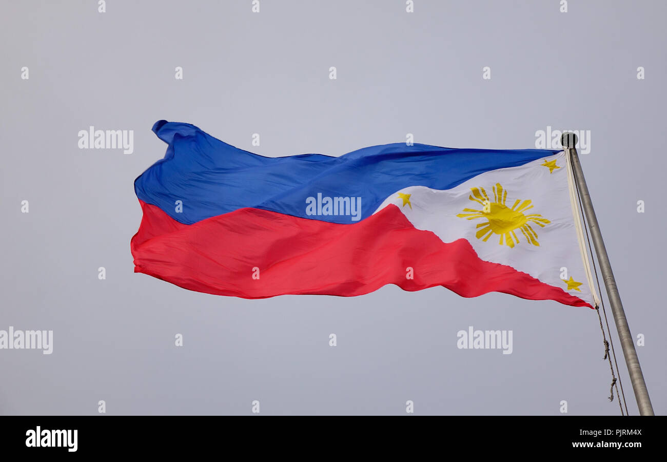 National flag waving in the sky at downtown in Manila, Philippines ...