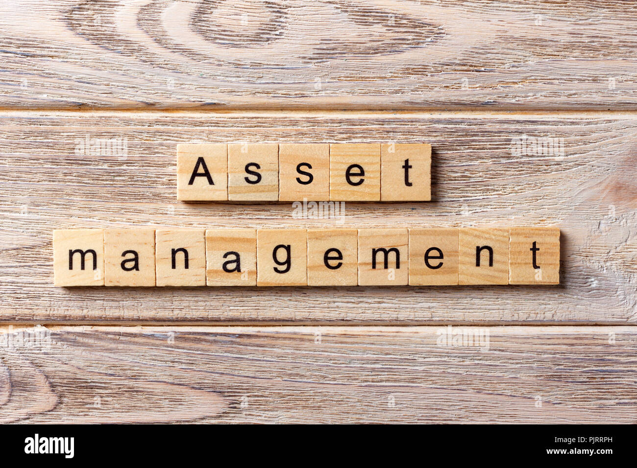 Asset Management word written on wood block. Asset Management text on ...
