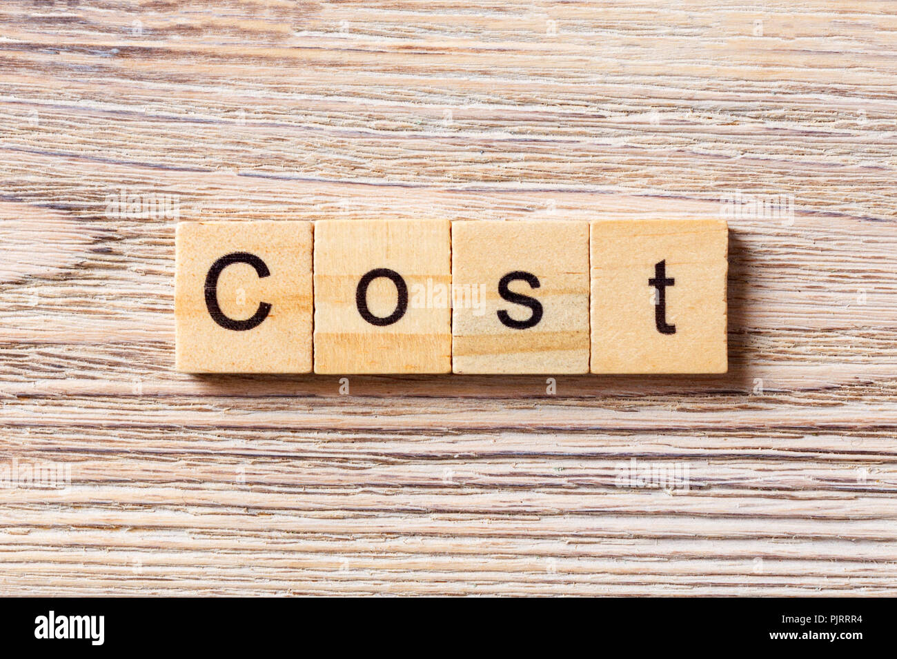 COST word written on wood block. COST text on table, concept Stock ...