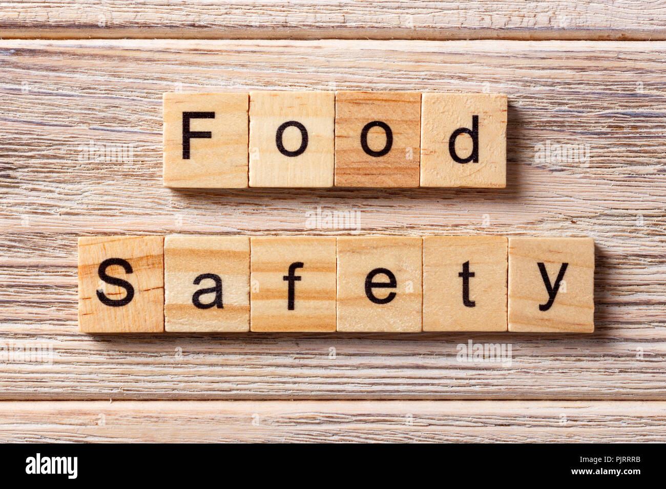 Food safety word written on wood block. Food safety text on table ...