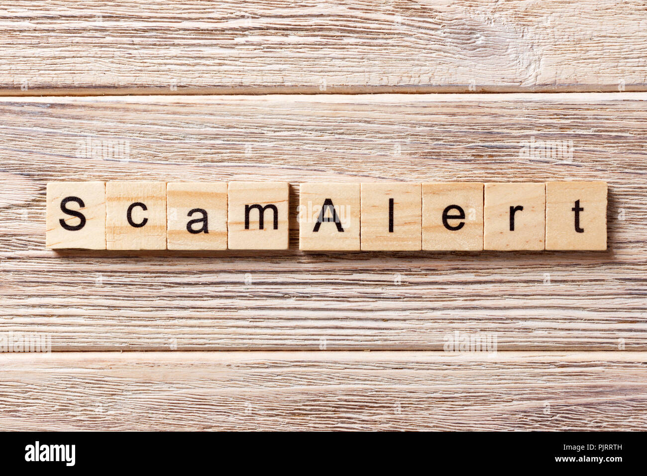 Scam alert word written on wood block. Scam alert text on table ...