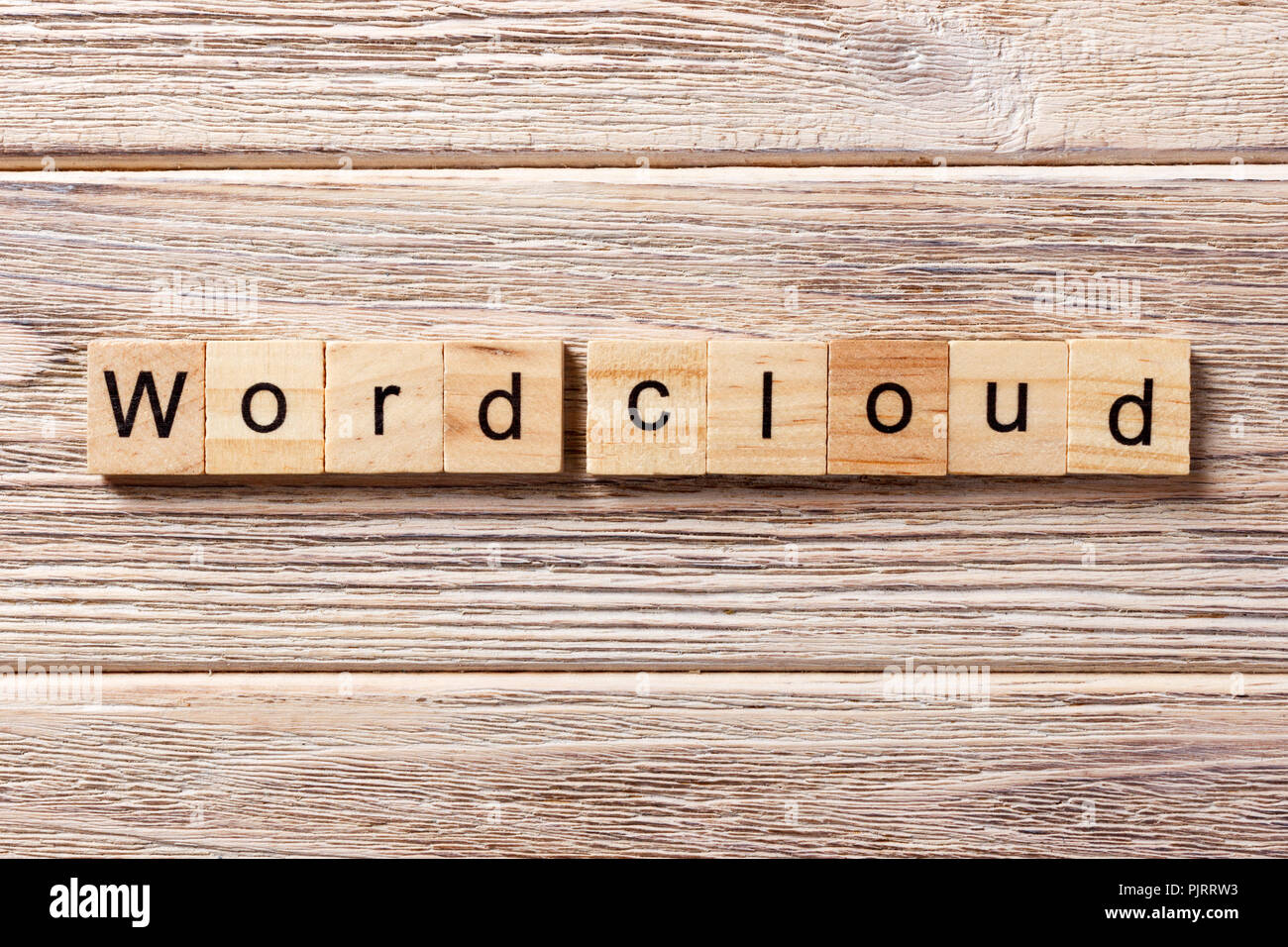 Word cloud word written on wood block. Word cloud text on table ...