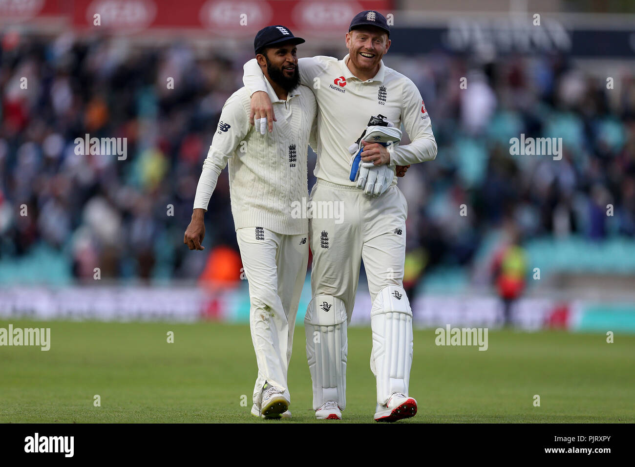 England's Adil Rashid and Jonny Bairstow (right) after the end of play ...
