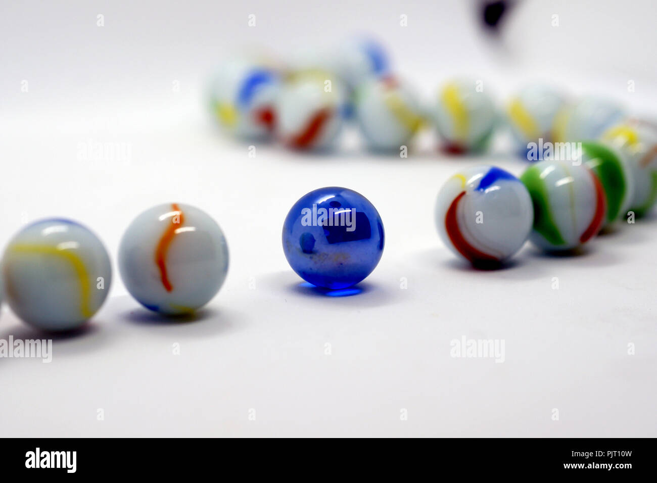 Red marbles one green marble hi-res stock photography and images - Alamy