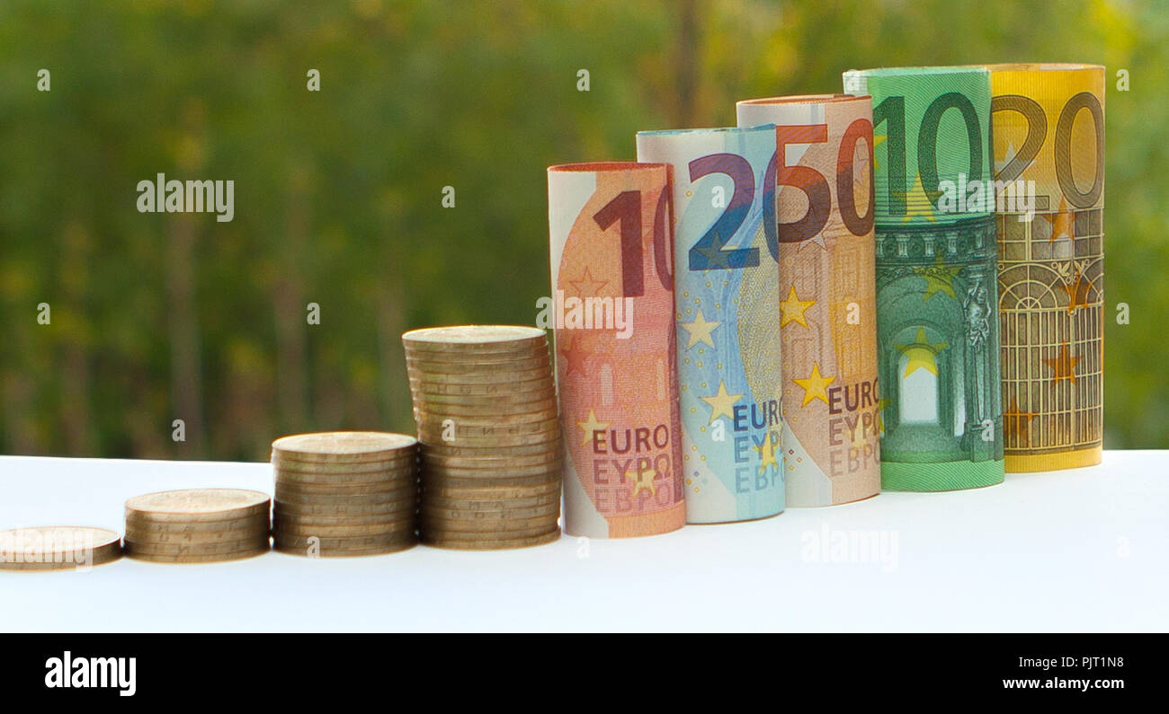 Histogram of coins and bamknotes on a green background. Concept of ...