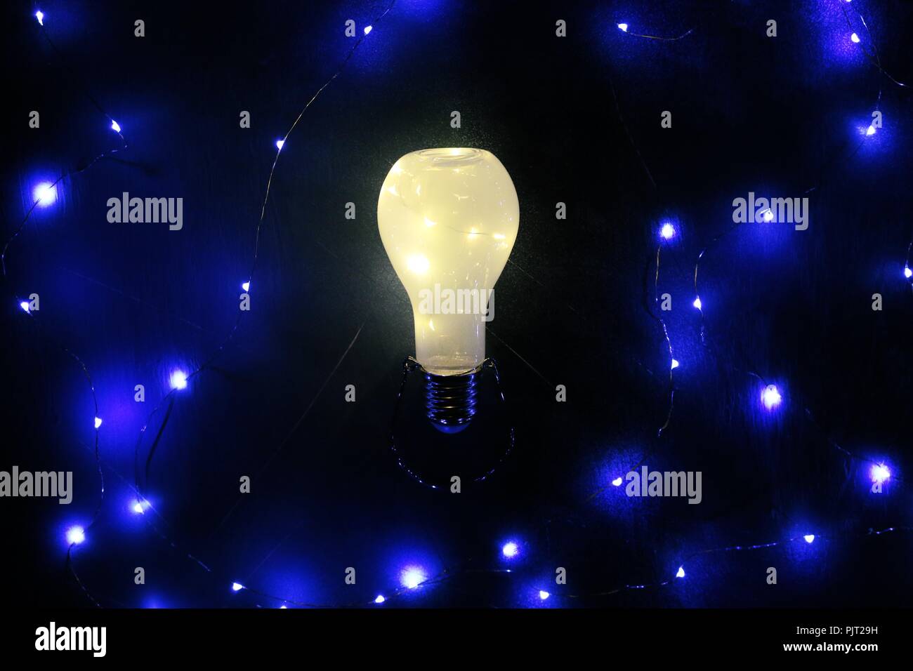 Glowing lightbulb on black background, idea concept Stock Photo - Alamy