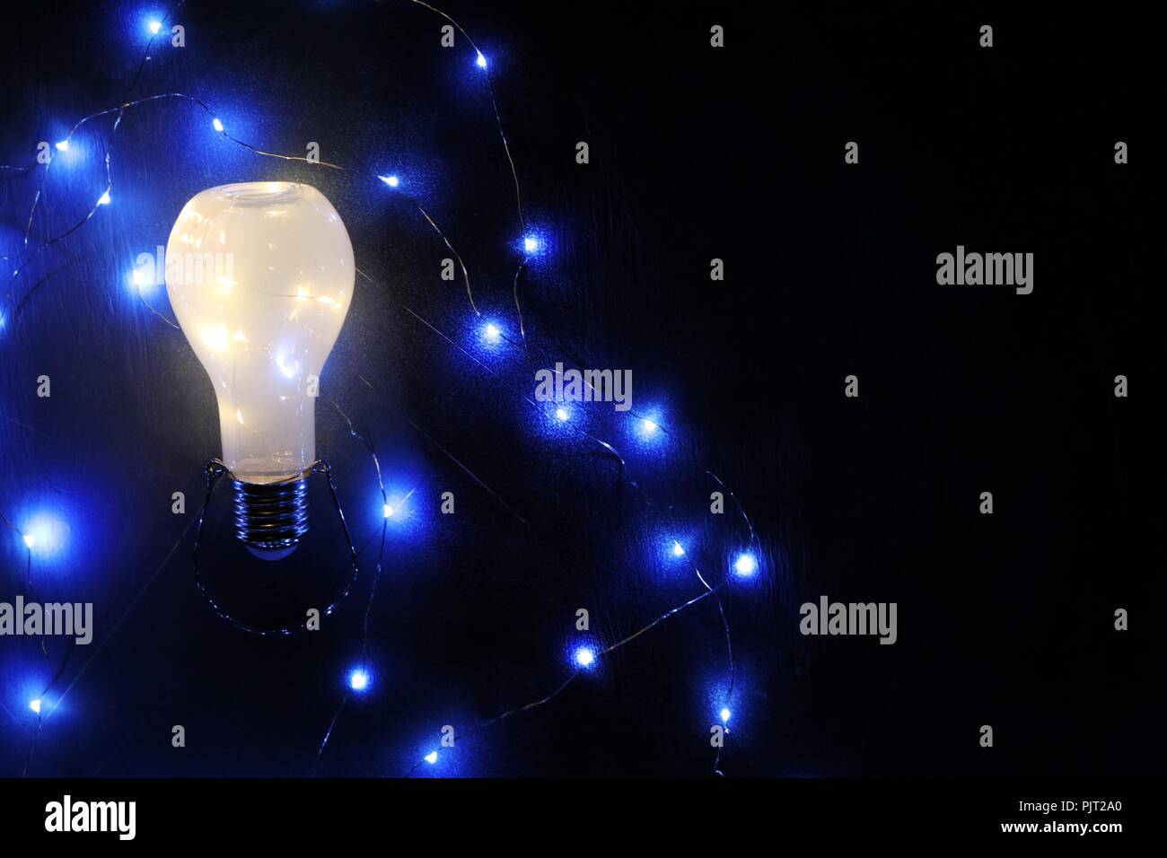 Glowing lightbulb on black background, idea concept Stock Photo - Alamy
