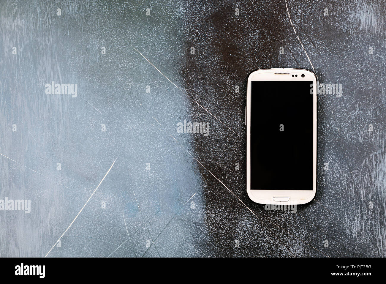 Smartphone on concrete wall background, top view Stock Photo - Alamy