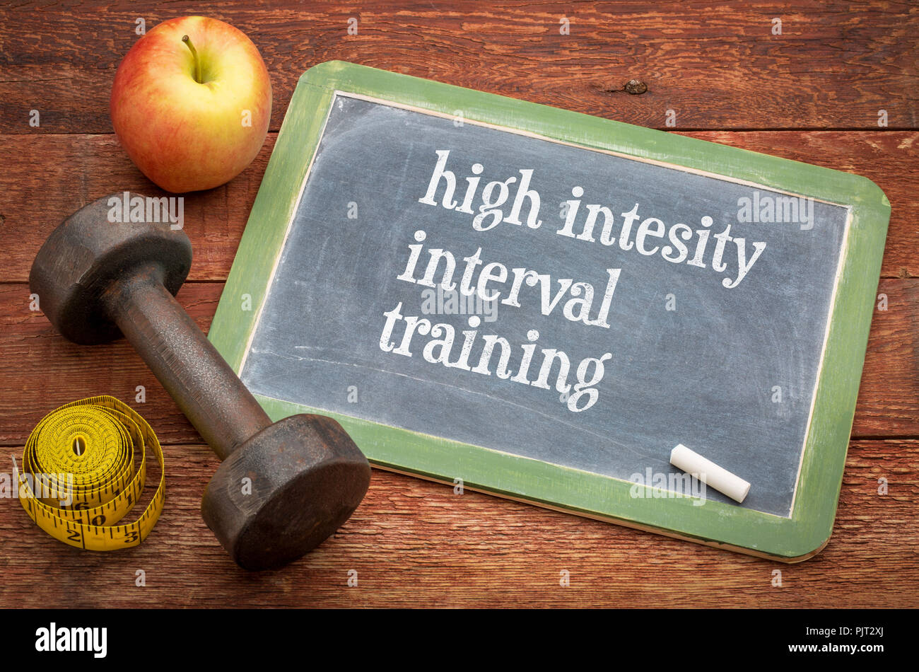 High intensity interval training - slate blackboard sign against rustic ...