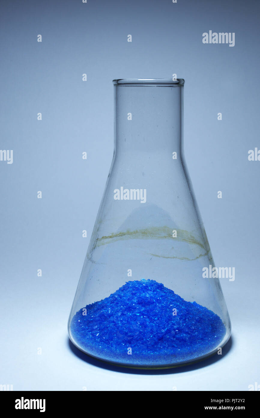 bright blue crystals in a heap, shines on bottom of Erlenmeyer flask ...