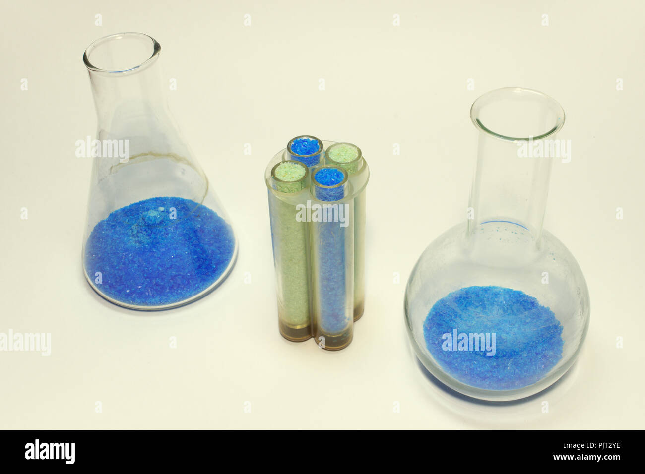green and blue chemical salts in laboratory glassware: Erlenmeyer and ...
