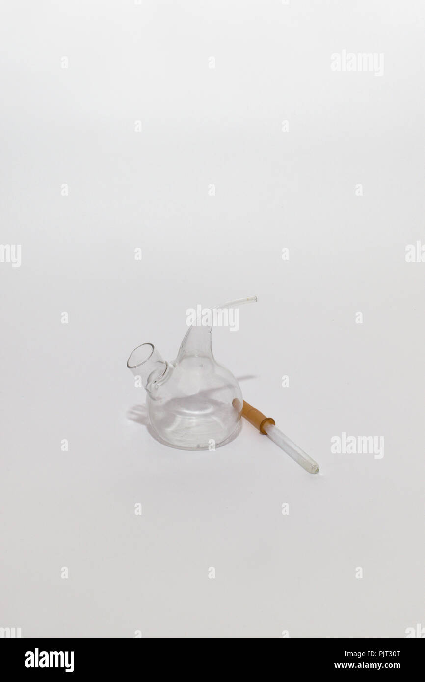 retort and glass eye dropper with rubber bulb attached. with copyspace ...