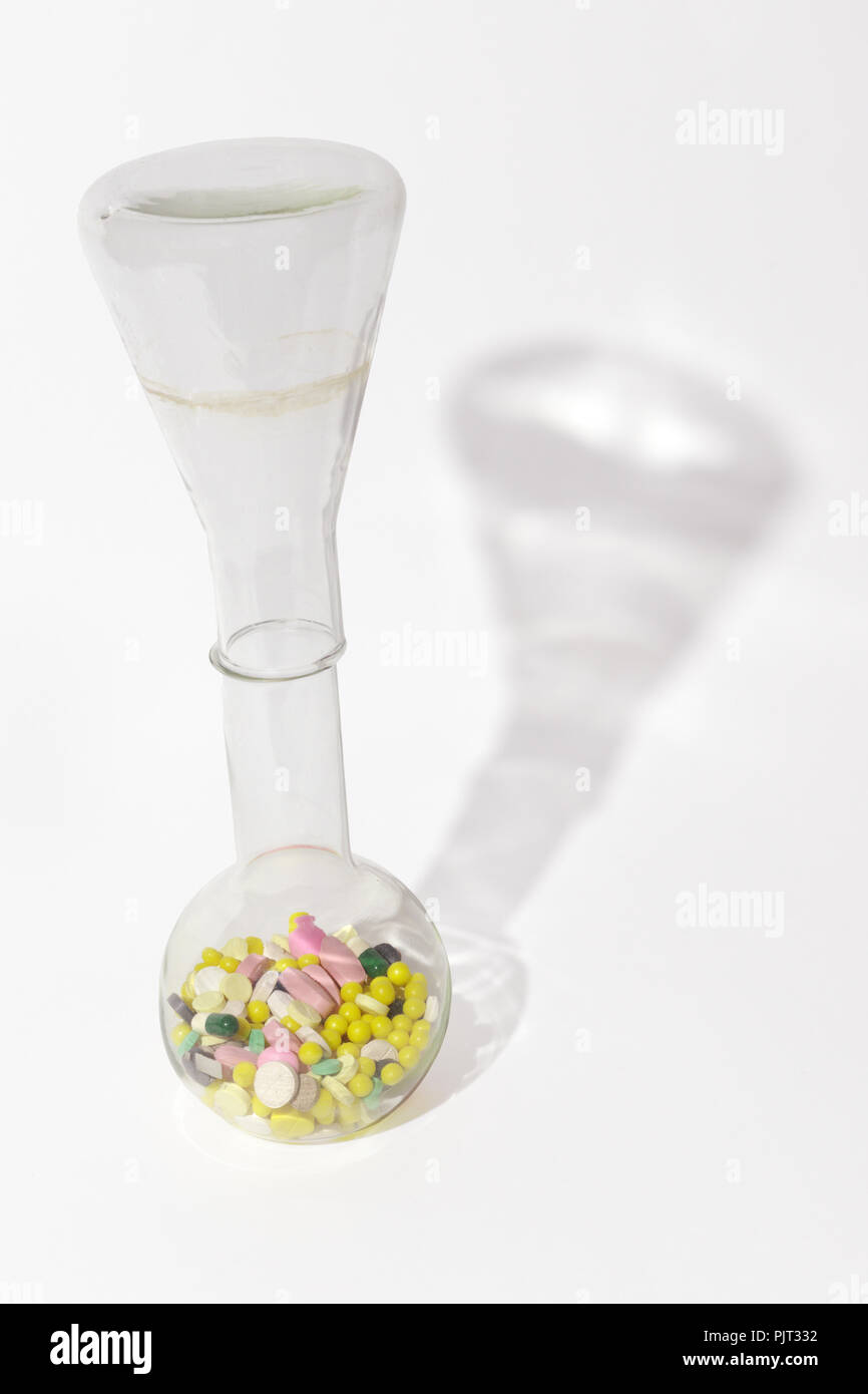 multicolored pills are transfused in lab glassware. upside down ... multicolored pills are transfused in lab glassware. upside down ...