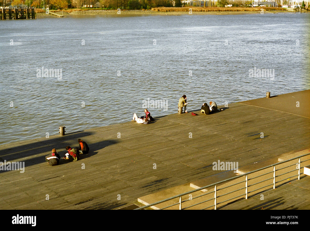 People relaxing on the Jordaenskaai on the borders of the Schelde river ...