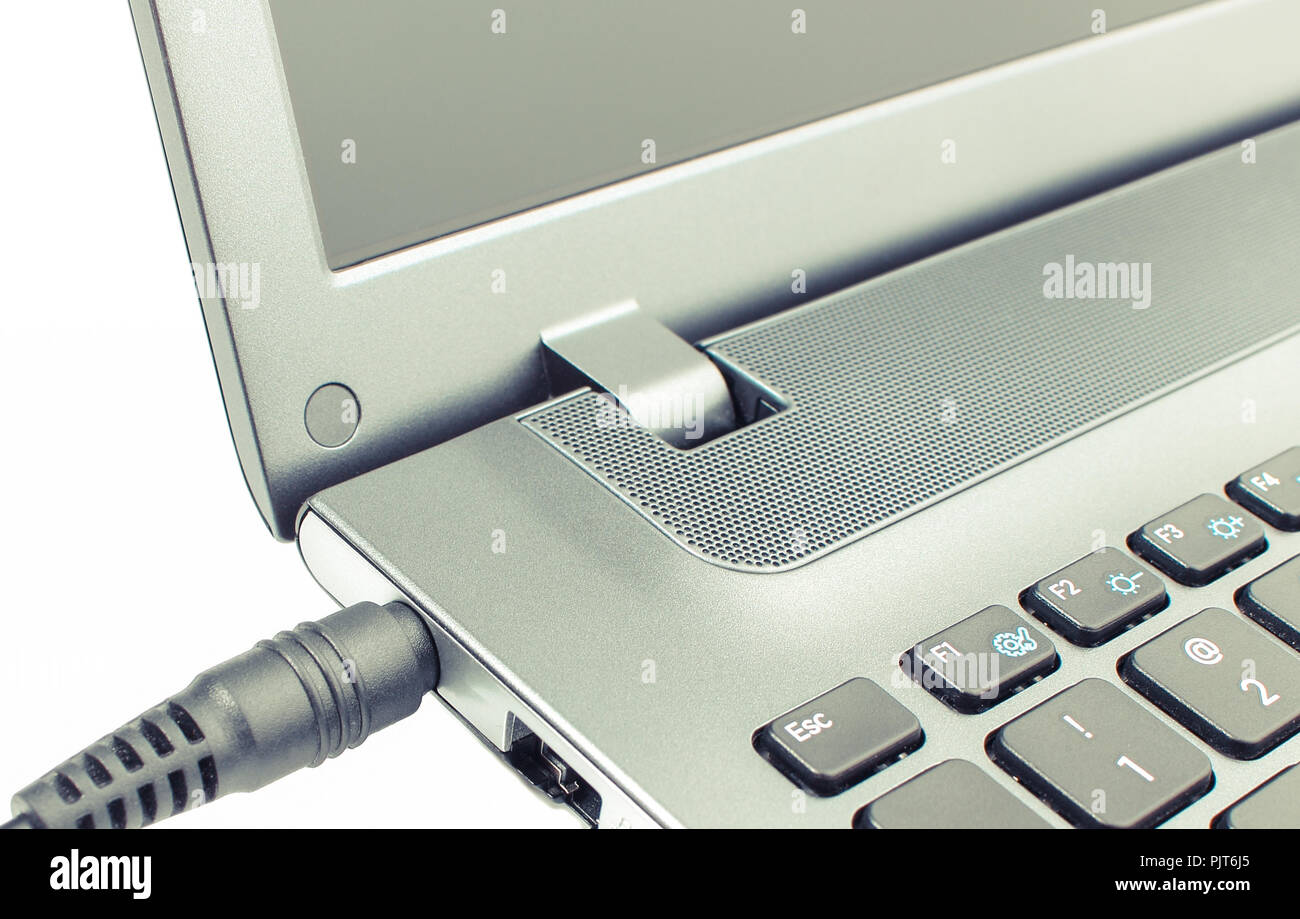 Plug of charger connected to laptop on white background Stock Photo - Alamy