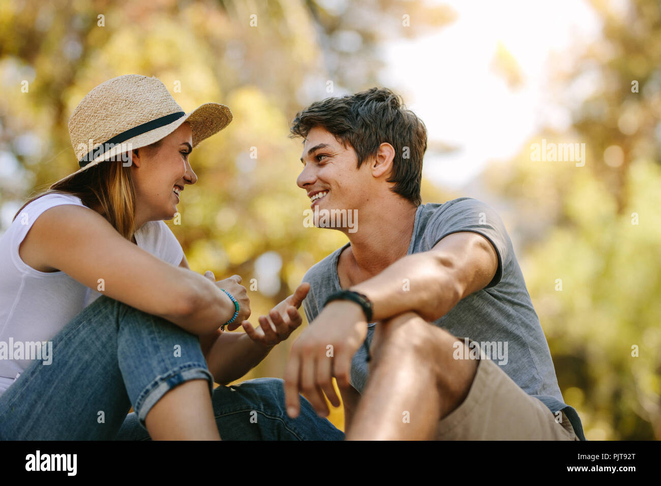 Two young people in a park talking hi-res stock photography and images ...