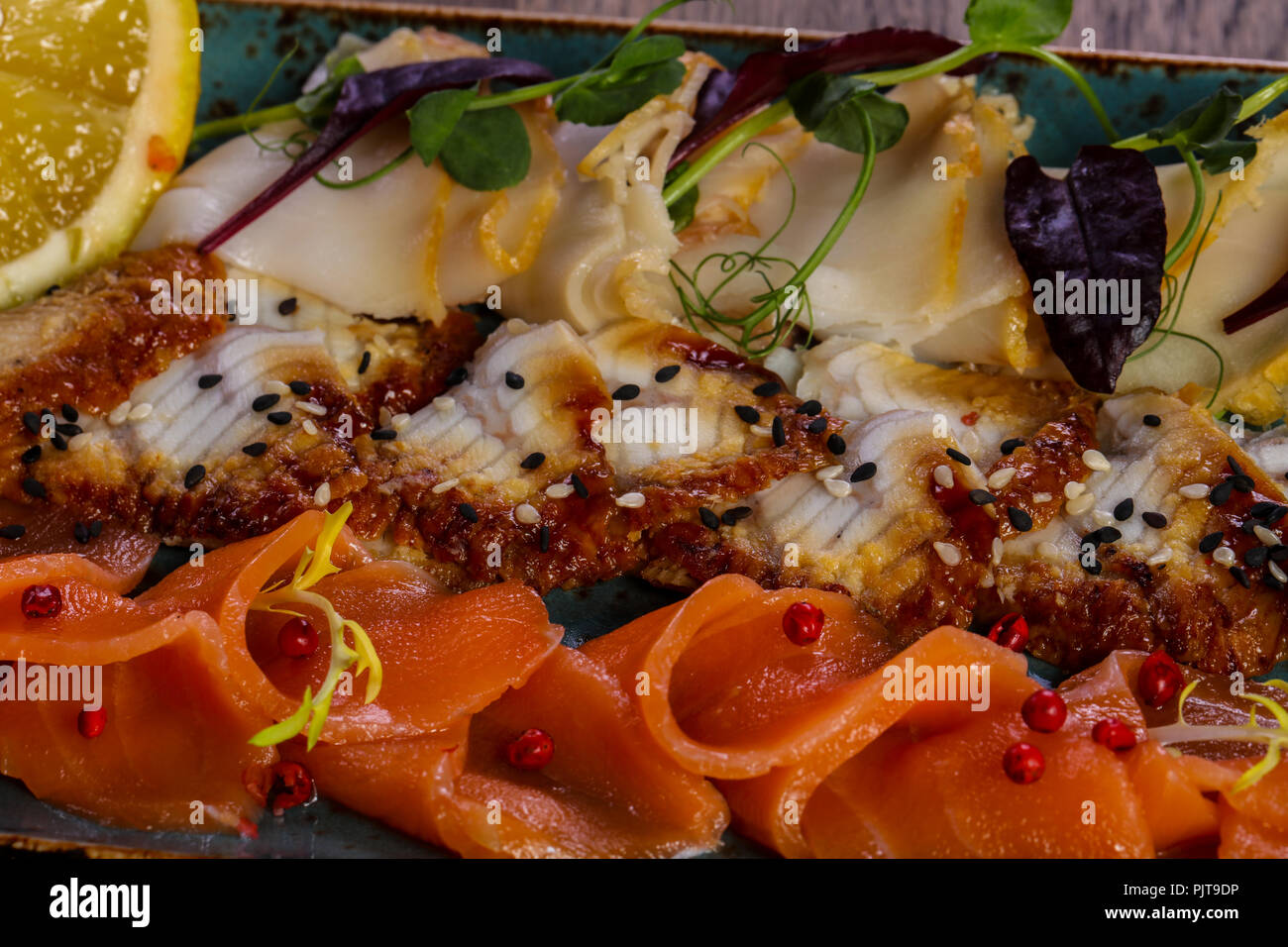 Sliced fish plate served lemon Stock Photo - Alamy