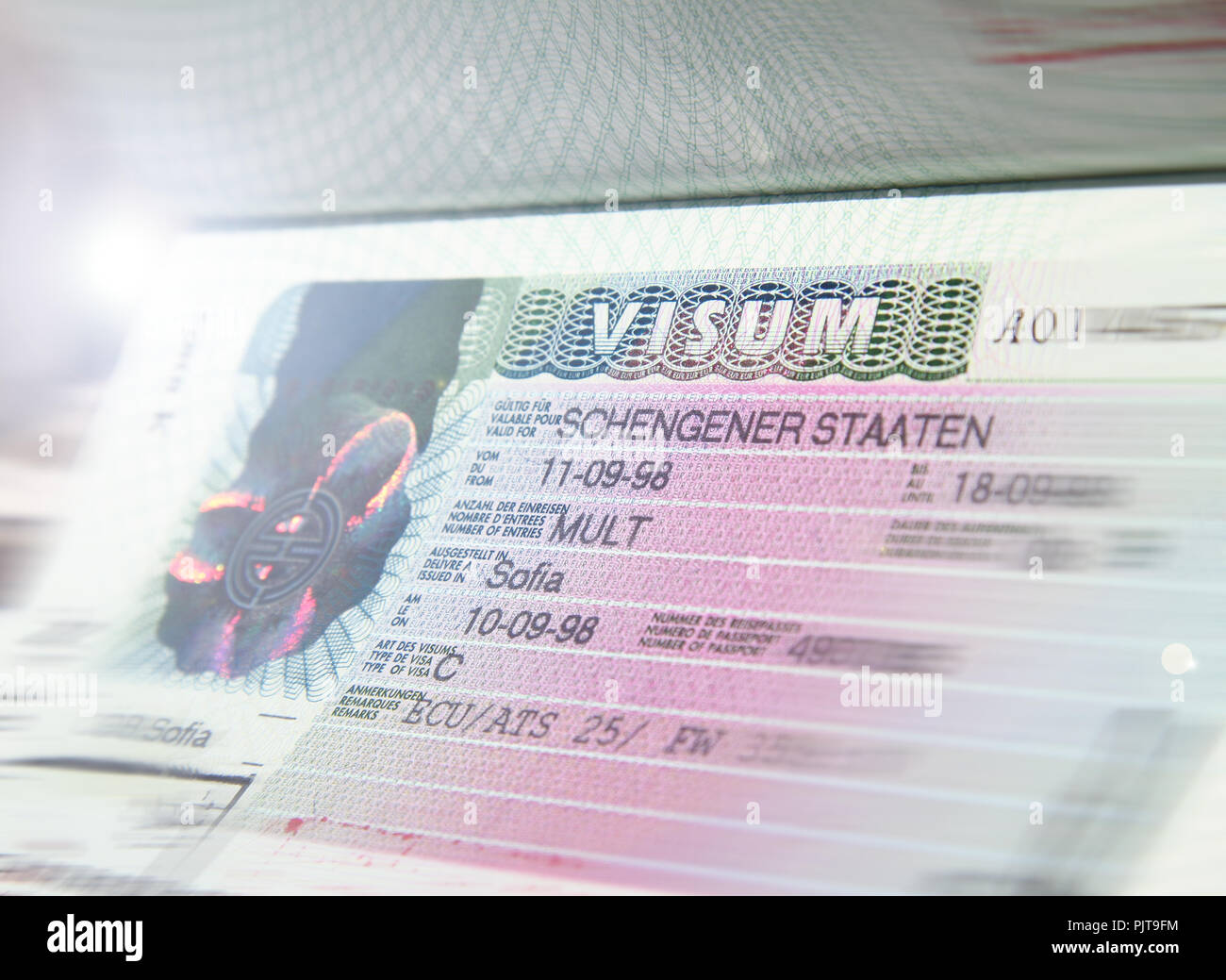 Schengen visa stamp in international passport. Shengen document for ...