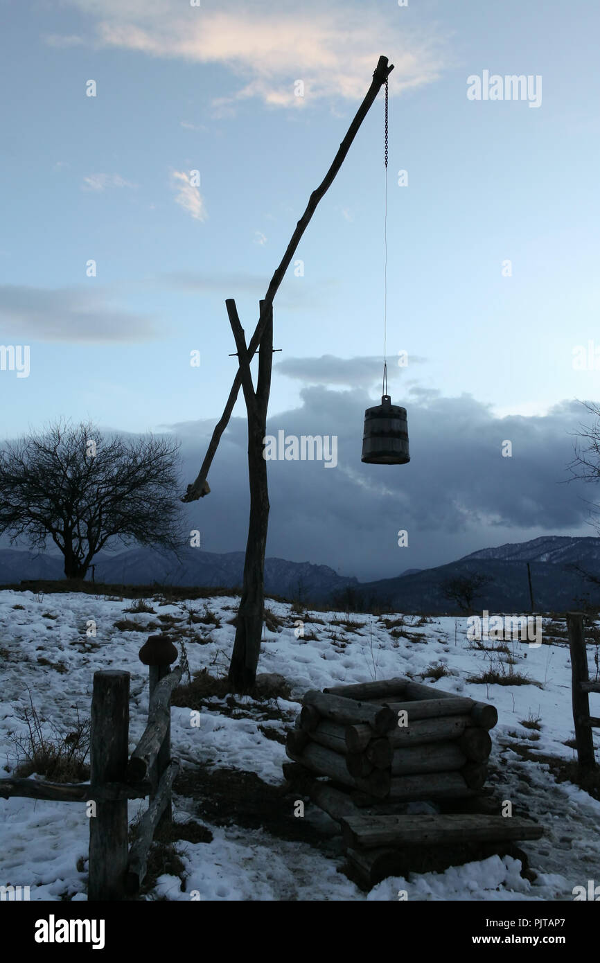 Ancient wooden pendulum type well in winter evening Stock Photo - Alamy