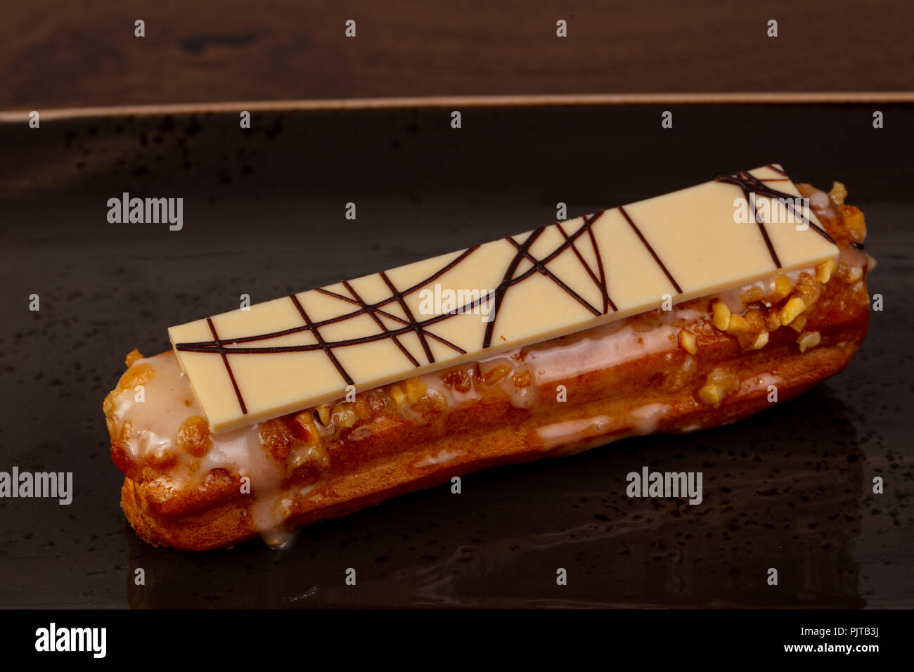 Tasty sweet Eclair with cream Stock Photo - Alamy