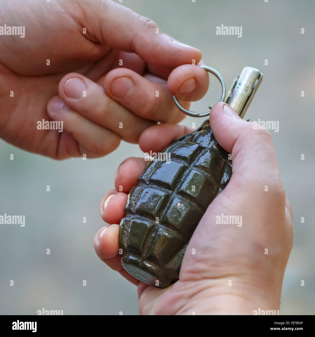 Hand grenade in hand pin hi-res stock photography and images - Alamy