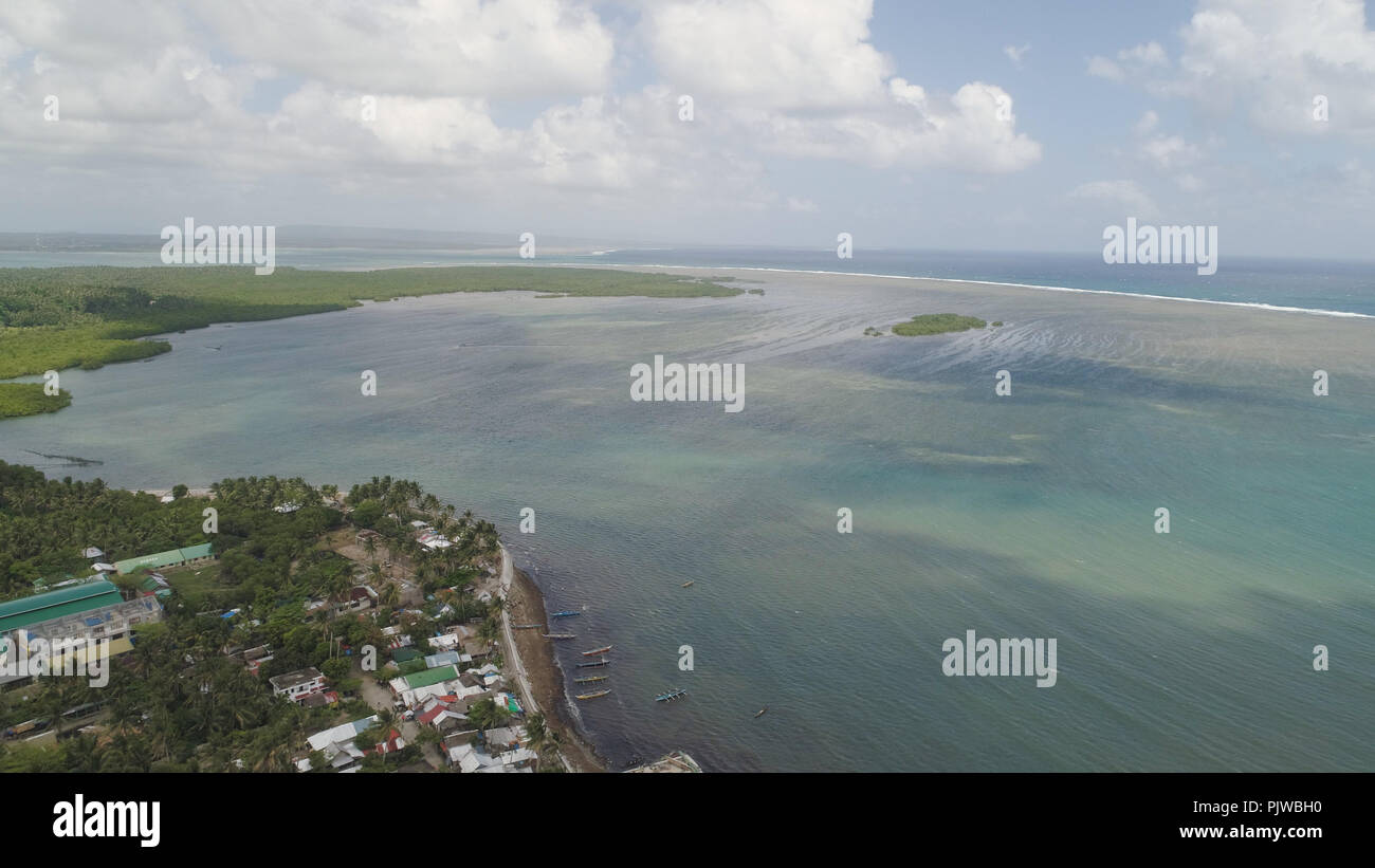 Aerial view of seashore with coastal town, beach, lagoons and coral ...