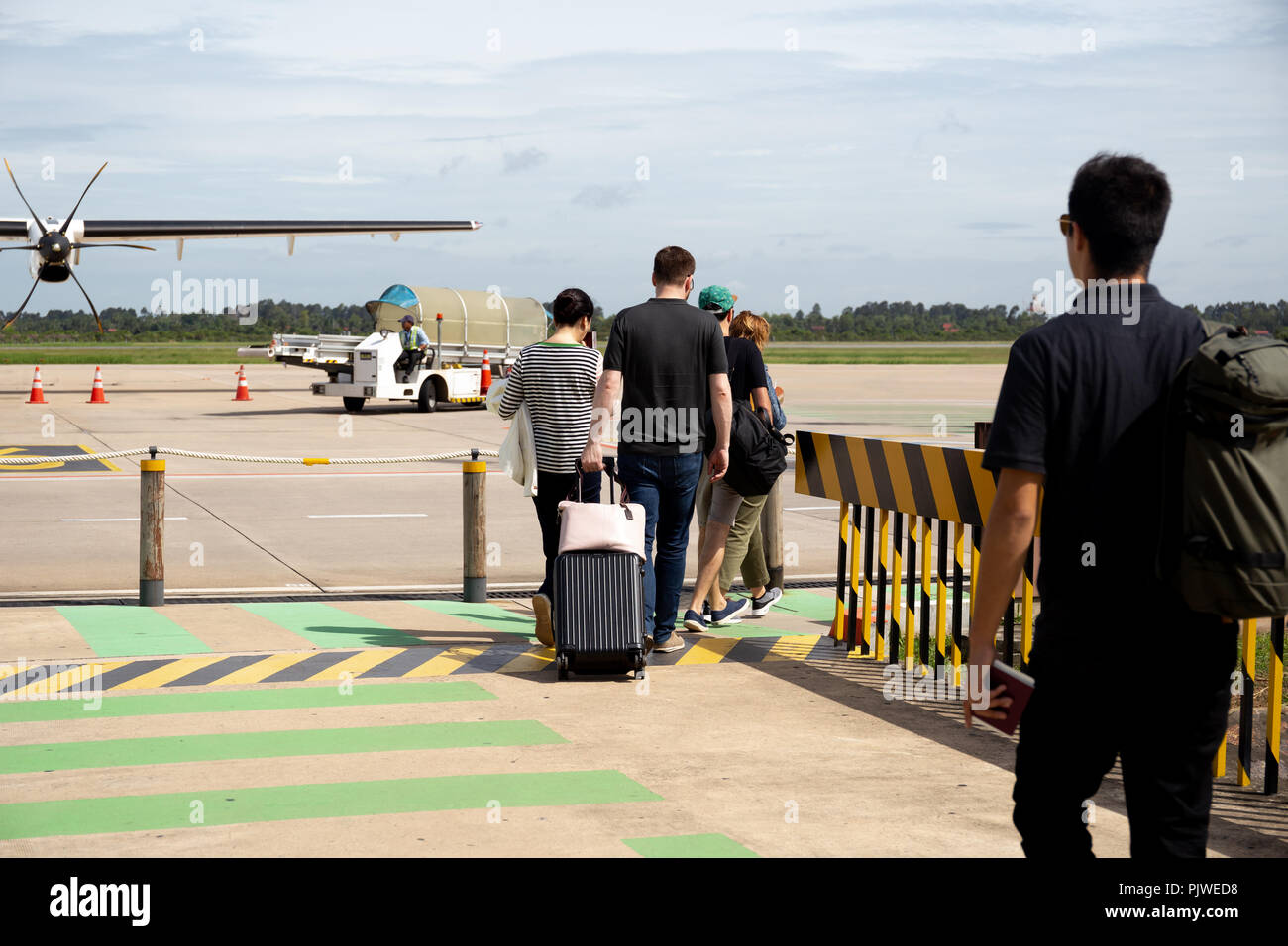 Airlines passengers boarding a plane for their international flight ...