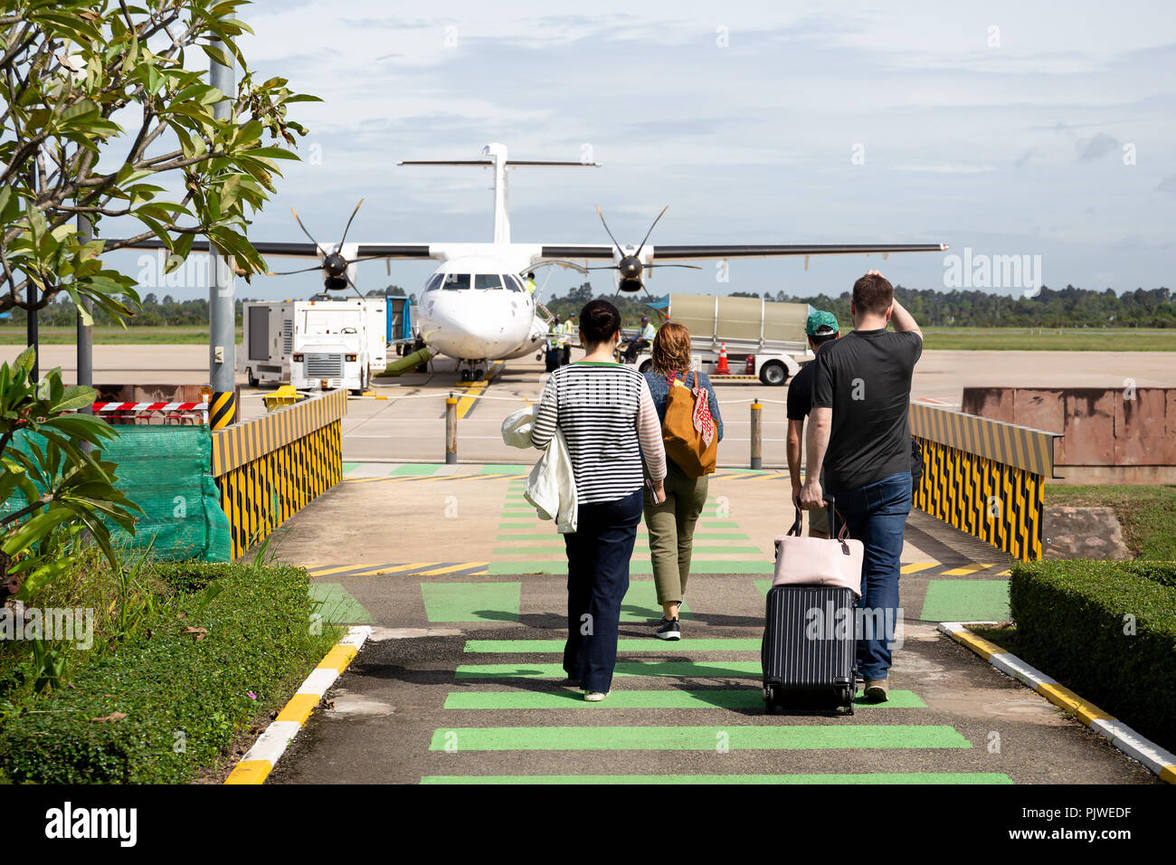 Airlines passengers boarding a plane for their international flight ...