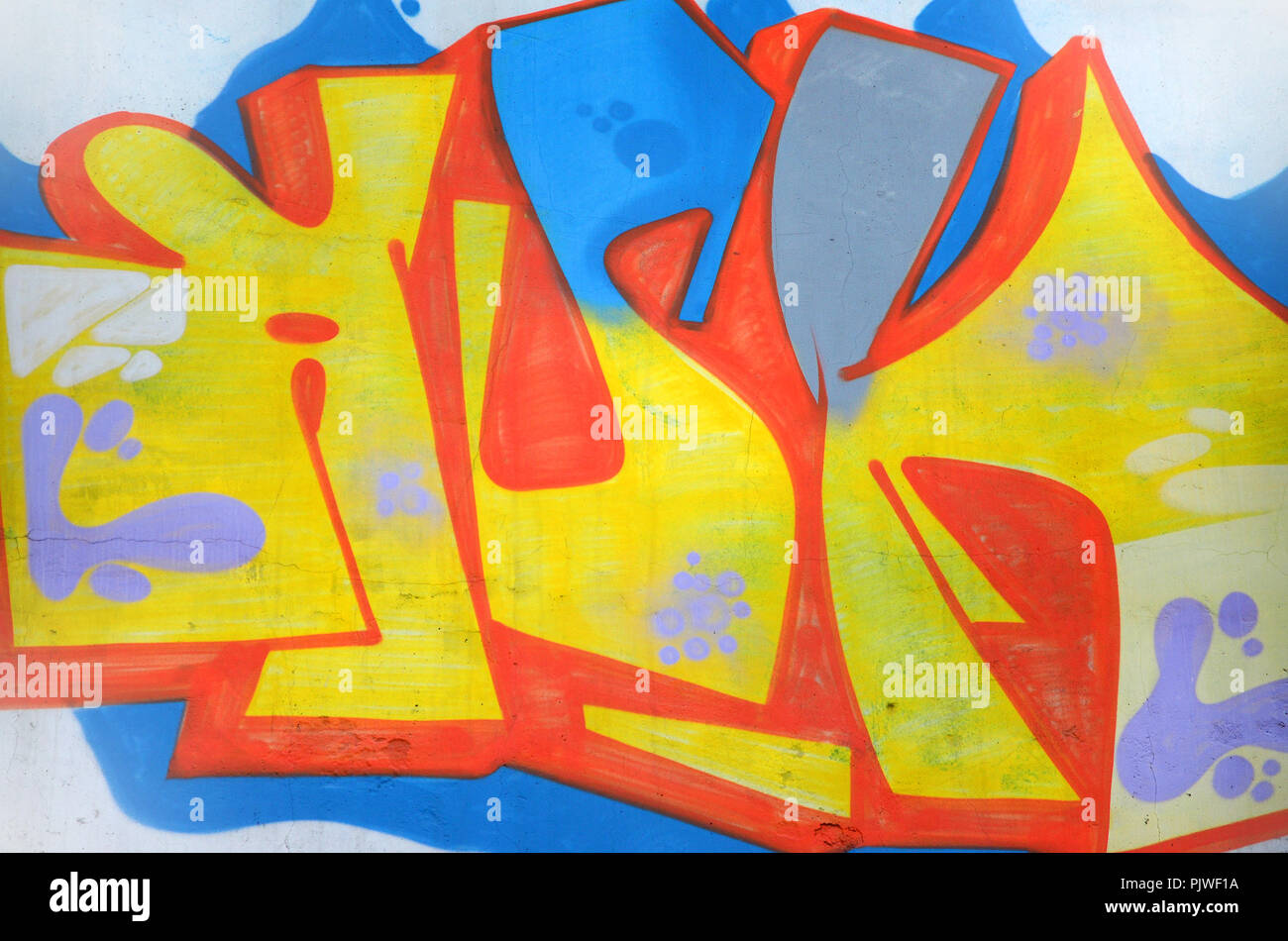 The old wall, painted in color graffiti drawing red aerosol paints ...