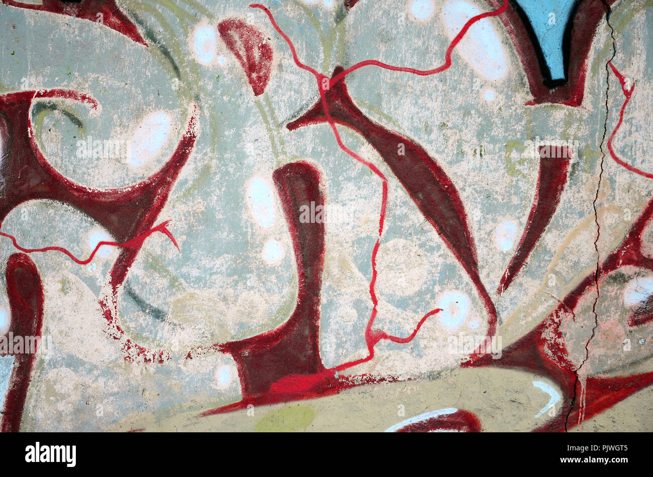 The old wall, painted in color graffiti drawing red aerosol paints ...